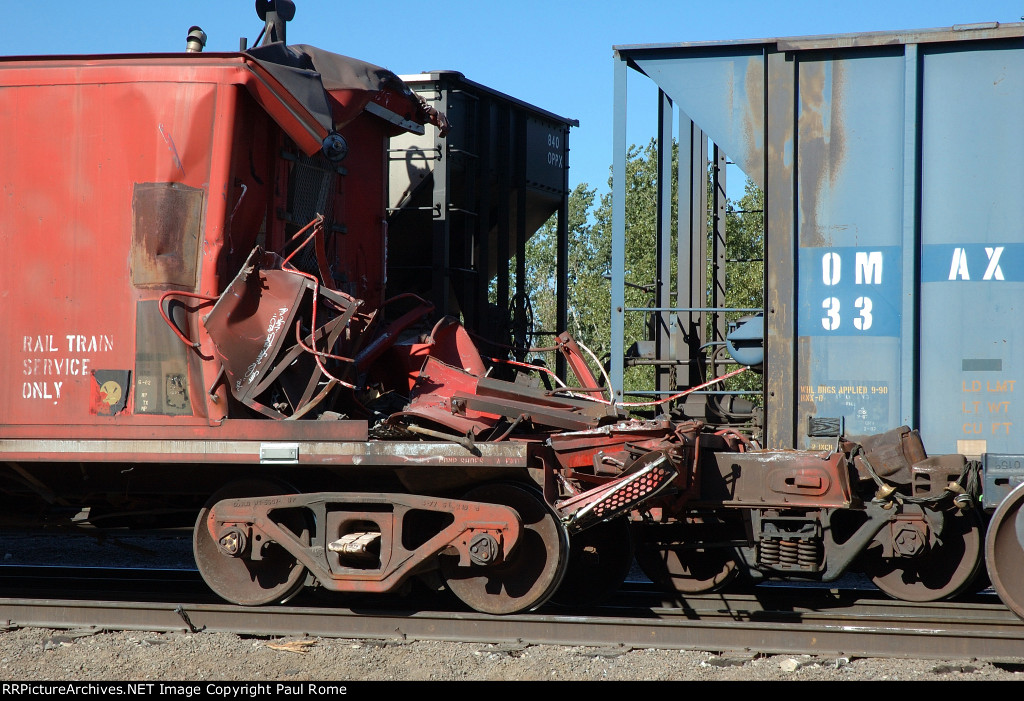 MP 7509, ex MoPac caboose damaged in a runaway collision of UP 9366 and between OMAX 1134 hopper